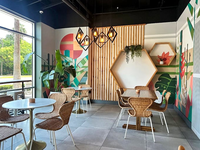 Mid-century modern meets tropical chic in this Instagram-worthy corner. The wicker chairs practically whisper, "Stay awhile and have another cappuccino."