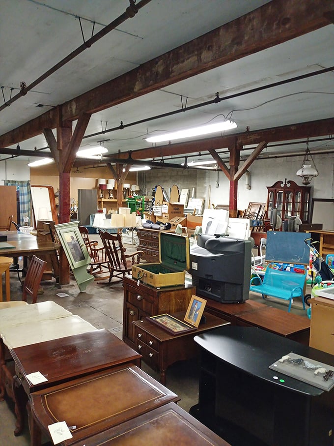 Exposed wooden beams overhead tell their own tales while vintage treasures below wait patiently for their next chapter to begin.