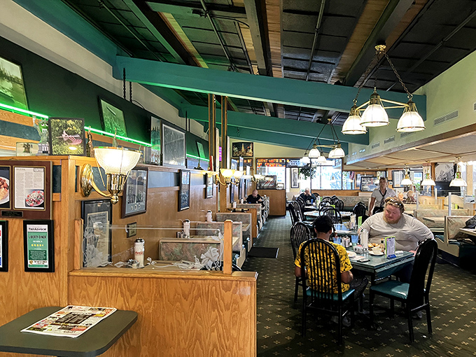 Inside, wooden booths and green accents create that perfect diner atmosphere where coffee flows freely and breakfast dreams come true.