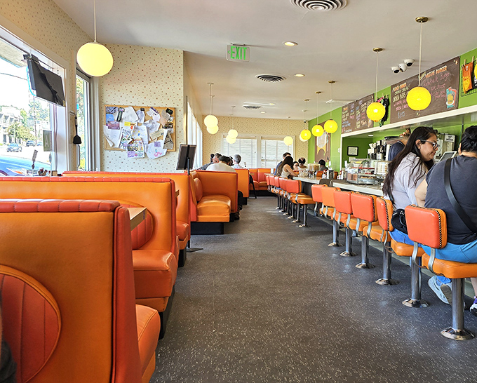 Step inside to a symphony of orange vinyl booths and globe pendant lights. This isn't manufactured nostalgia—it's the real deal that's survived decades.