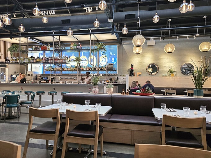 Modern meets retro in this sleek interior where globe lights cast a warm glow over conversations waiting to happen.