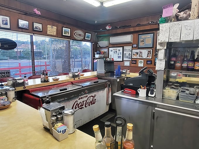The vintage Coca-Cola cooler isn't just decoration—it's a time machine to when diners were the cornerstone of American social life.