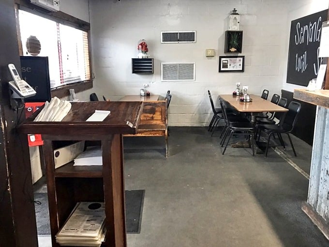 No-frills dining room where conversations flow as freely as sweet tea. The chalkboard's "Serving Local" sign tells you everything you need to know.