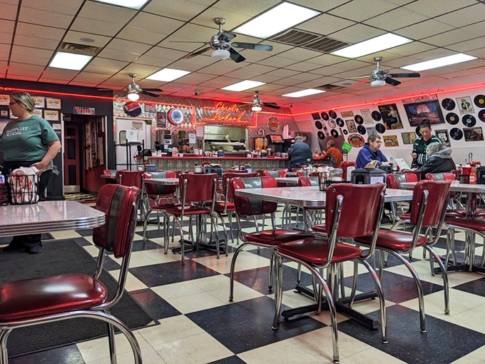 Classic Americana in full swing—red vinyl chairs, checkered floors, and vintage records create a time capsule where calories don't count and coffee never stops flowing.