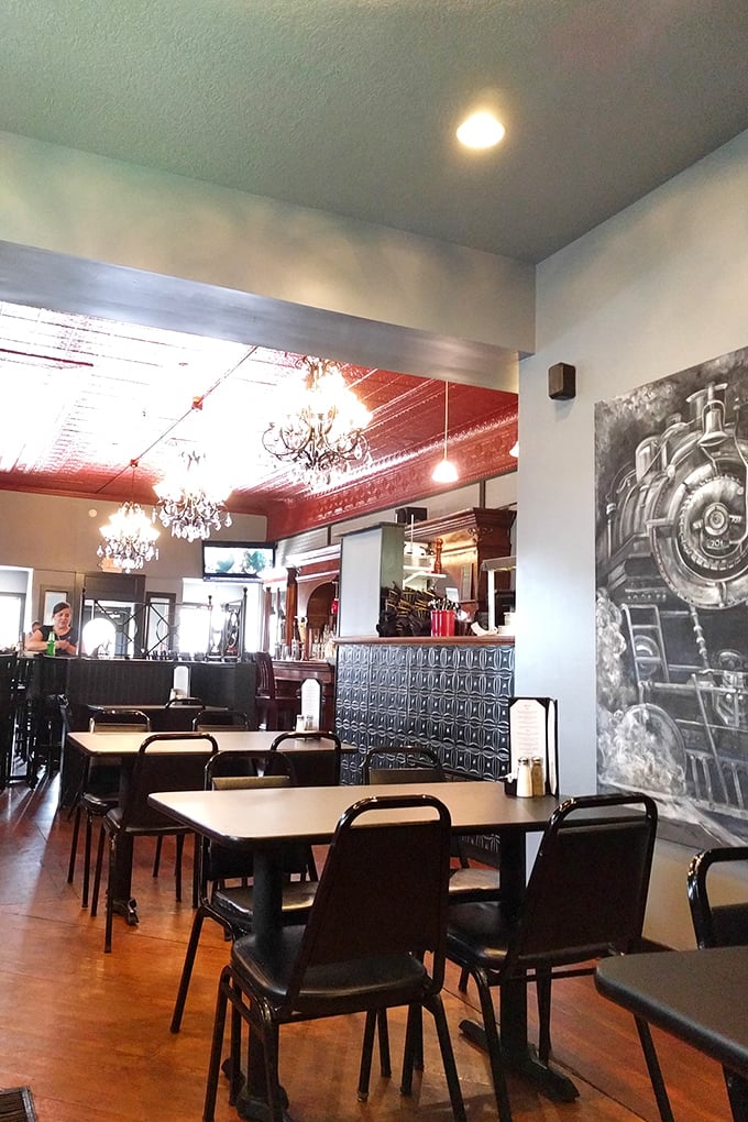 Step inside to discover elegant chandeliers hanging from a striking red tin ceiling—small-town Indiana meets unexpected sophistication.