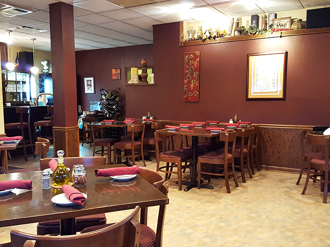 Warm burgundy walls and wooden tables create that perfect "come as you are, leave as family" atmosphere that defines great Italian dining.