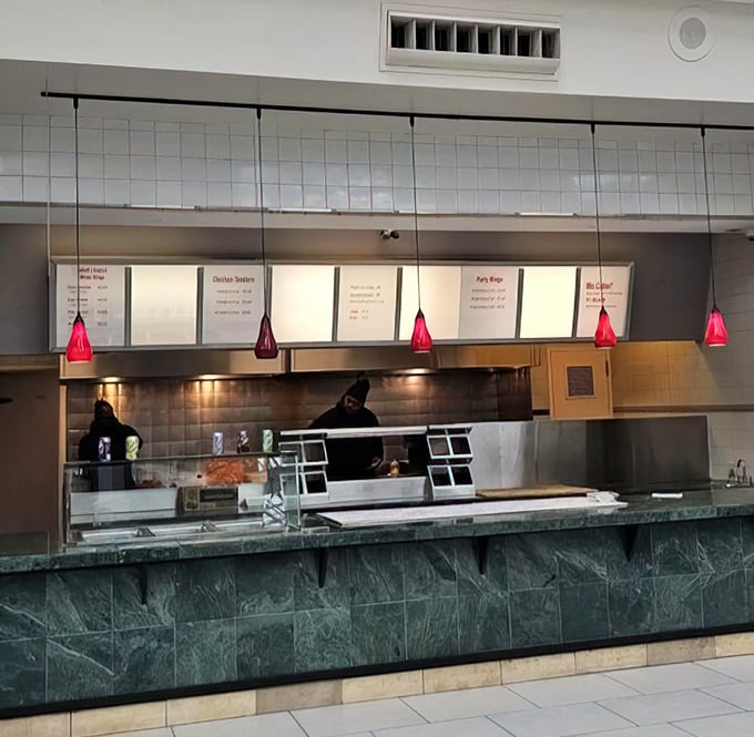 Behind the counter, culinary magic happens. Those red pendant lights aren't just for show—they're beacons guiding hungry souls to chicken nirvana.