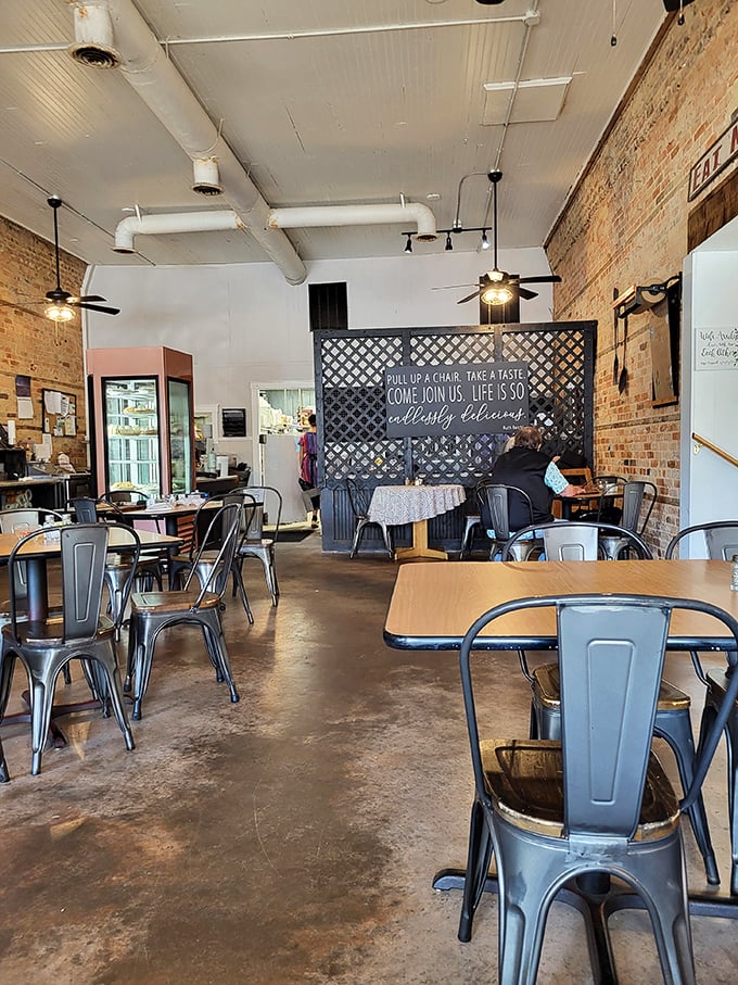 Exposed brick walls and industrial ceiling pipes create that perfect "discovered gem" atmosphere. The sign says it all: "Life is so daily delicious" when you're in the right place.