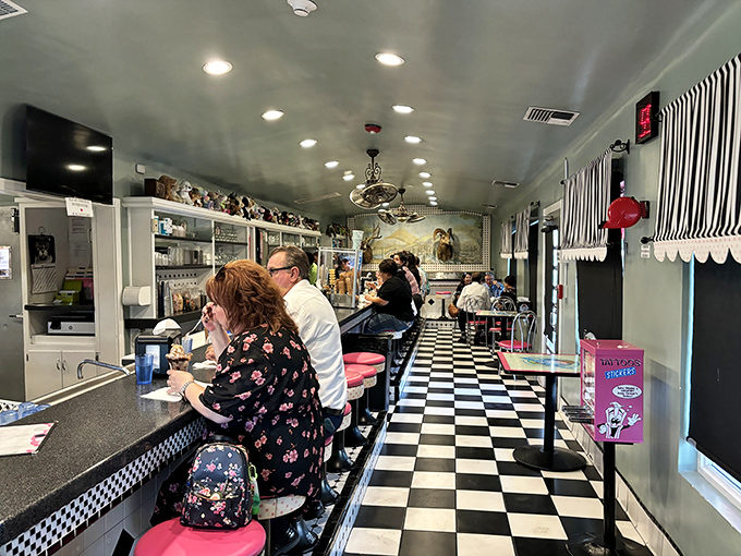 The classic black and white checkered floor and pink counter stools aren't retro by design—they're authentic survivors from a sweeter, simpler era.