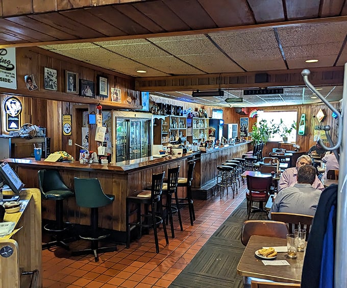 Step inside and time stands still – wood paneling, sports memorabilia, and a bar where everybody might not know your name yet, but they will by dessert. 
