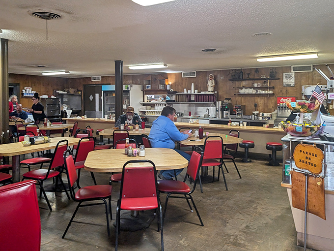 Classic red vinyl chairs and wood-paneled walls – this isn't interior design, it's a time machine to when comfort food actually comforted.