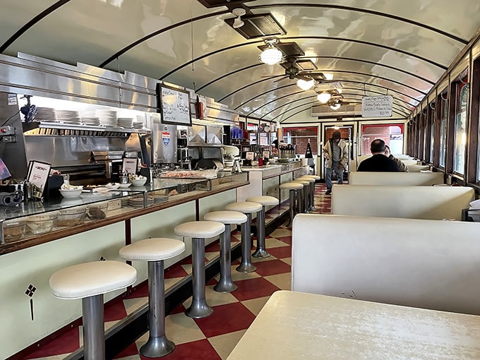 Classic Americana at its finest—red and white checkerboard floors, curved ceiling, and counter seating that practically whispers, "Sit down, stay awhile, order seconds."