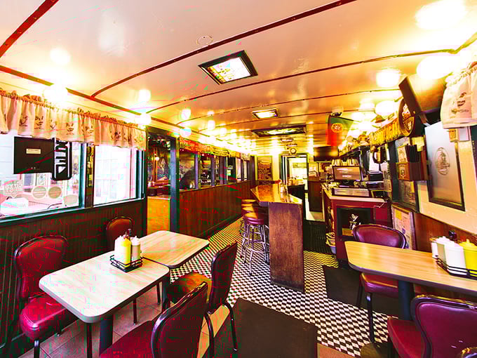 Step inside and you're transported to a bygone era—this narrow, railroad-car interior with checkered floors and cozy booths feels delightfully frozen in time.