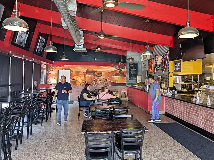Red ceiling beams frame a cozy dining space where carnitas dreams come true. Simple tables, big flavors—exactly as it should be.
