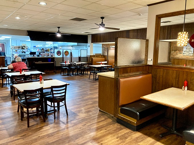 Wood paneling and comfortable booths create that perfect small-town restaurant atmosphere where conversations flow as easily as the coffee refills.