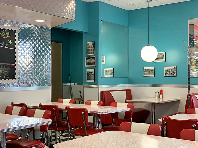 Stepping into this turquoise-and-red time capsule feels like being transported to an era when conversations happened face-to-face and coffee refills were infinite.