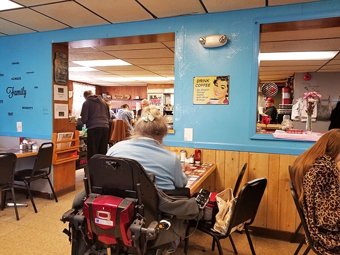 Blue walls and wood paneling create that classic diner atmosphere where coffee flows freely and conversations buzz like the best background music.