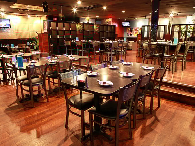 Inside, warm wooden floors and dividers create intimate dining spaces where seafood dreams come true. No white tablecloths needed when the food does all the talking.