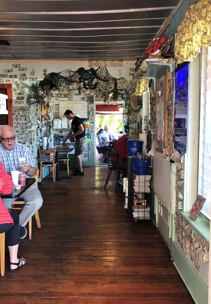 Dollar bills and fishing nets line walls that have witnessed countless seafood celebrations. This isn't décor—it's a maritime museum with table service.