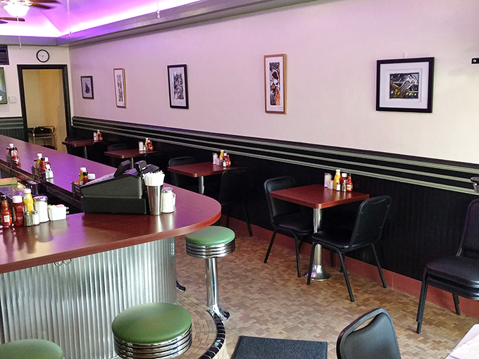 Classic diner aesthetics done right—red tables, black booths, and mint green counter stools that have cradled countless breakfast enthusiasts' behinds since opening day.