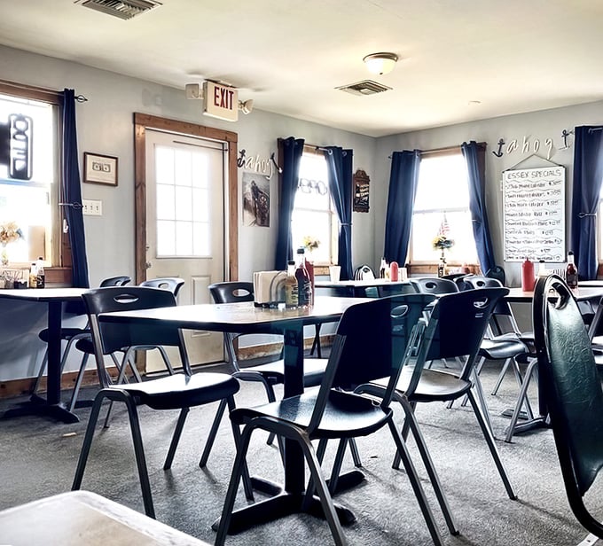 Simple tables, navy curtains, and nautical touches create the perfect backdrop for seafood stardom – no white tablecloths needed when the food's this good.