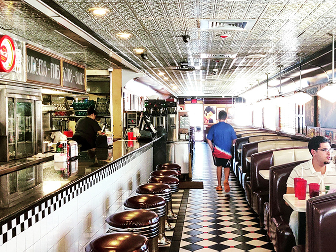 Step inside and the 1950s welcome you with open arms. That black and white checkered floor isn't just decoration—it's your invitation to the dinner table of American nostalgia.
