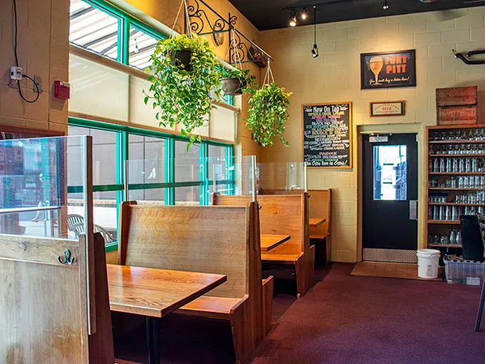 Cozy wooden booths create intimate spaces where beer conversations flow as smoothly as the taps.