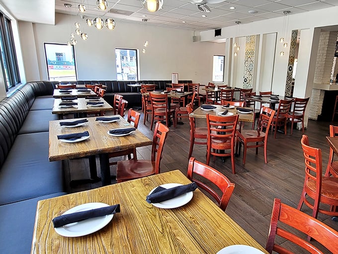 Inside, reddish-brown chairs and warm wooden tables create the perfect backdrop for the food drama about to unfold. Comfort meets style in this thoughtfully designed dining room.