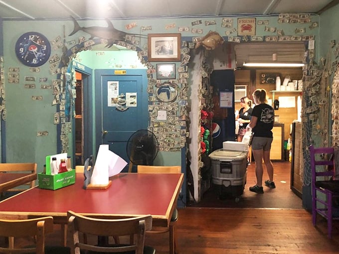 Dollar bills paper the walls like a quirky financial wallpaper. In this seafood sanctuary, the décor is as authentic as the catch.