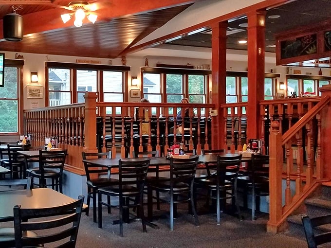 Warm wood tones and thoughtful dividers create intimate dining spaces without sacrificing the convivial atmosphere that makes regulars feel at home.