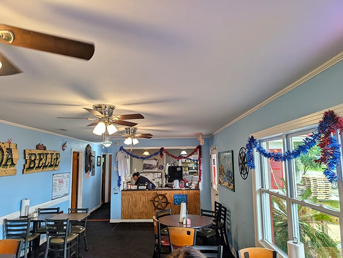 Blue walls, ceiling fans, and nautical touches create the perfect seafood sanctuary. This isn't designer coastal chic—it's the real Florida, where the focus stays squarely on what matters. 