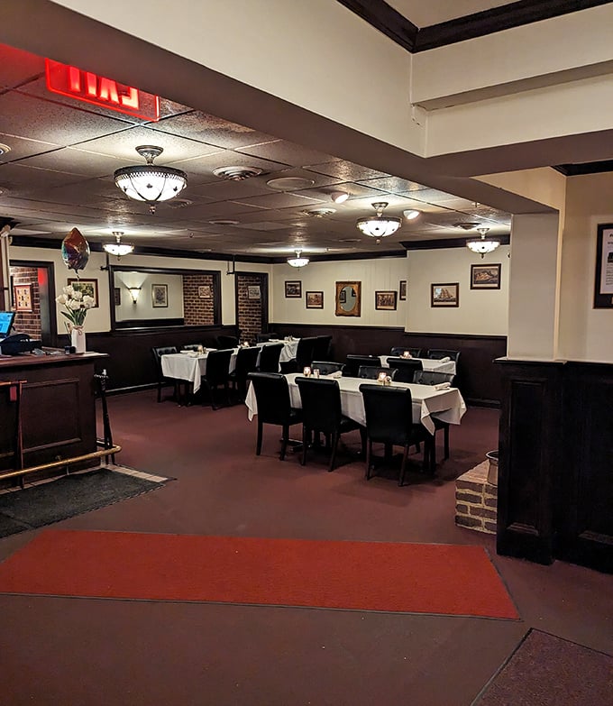 Classic steakhouse elegance awaits inside – white tablecloths, dark wood paneling, and lighting dim enough to make everyone look like movie stars.