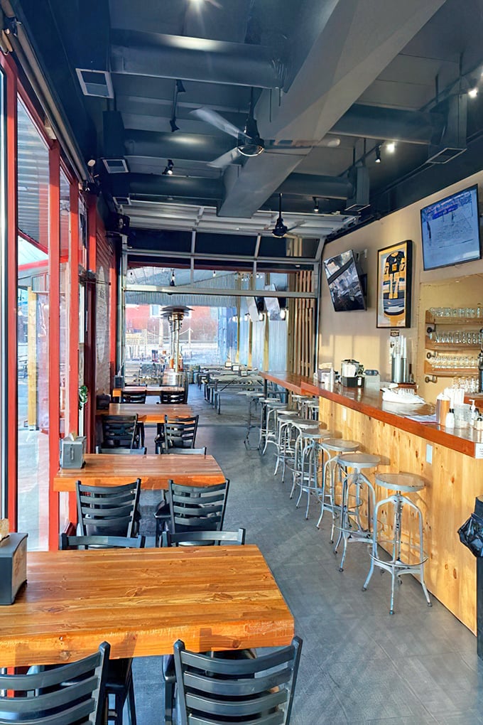Industrial meets comfort in this space where serious barbecue business happens. The wooden tables are just waiting for your elbows and satisfied sighs.
