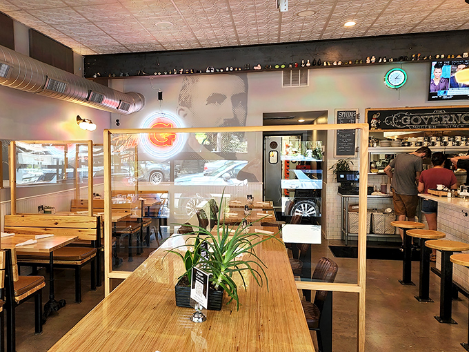 Industrial-chic meets cozy comfort inside, where wooden tables and modern dividers create an atmosphere that's both trendy and welcoming.