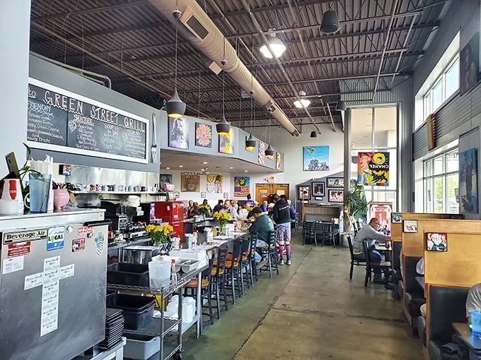 Industrial chic meets neighborhood comfort—exposed ceilings, colorful art, and that unmistakable breakfast energy filling every corner.