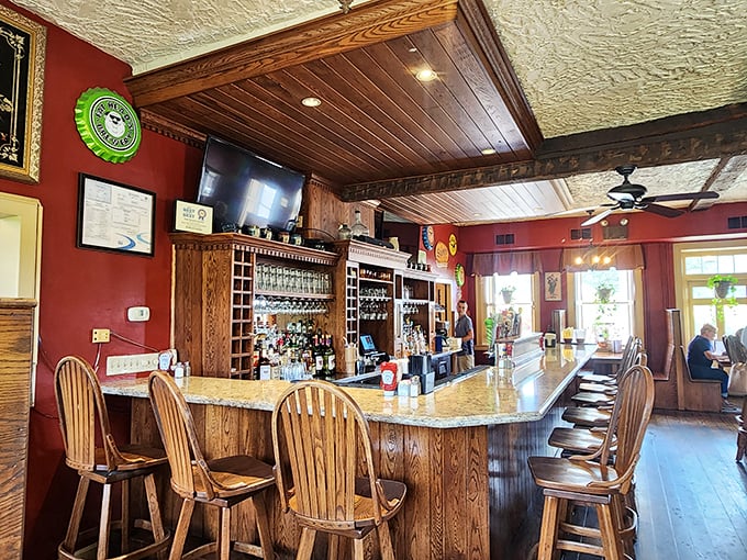 The bar where revolutionary whispers once filled the air now welcomes modern-day travelers with Windsor chairs, rich wooden textures, and the promise of colonial-era hospitality.