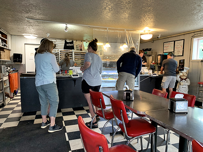 Inside Joe's, the classic black and white floors and red chairs create a timeless backdrop for the main event—donuts that make grown adults giggle with anticipation.