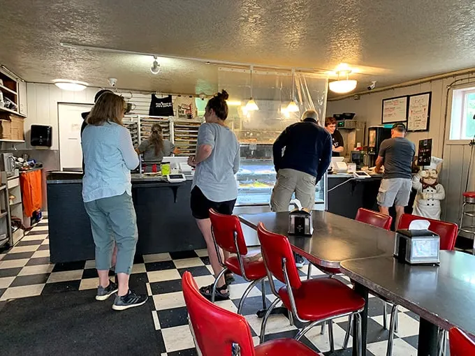 Inside Joe's, the classic black and white floors and red chairs create a timeless backdrop for the main event—donuts that make grown adults giggle with anticipation.