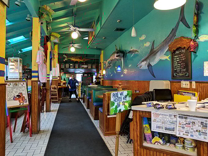 Ocean meets art inside this seafaring sanctuary. Turquoise walls, mounted fish, and wooden accents create the perfect backdrop for seafood feasting and vacation storytelling.