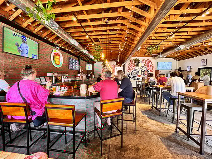 Exposed wooden beams and brick walls create the perfect rustic-meets-urban vibe, where beer flows and conversation buzzes as freely as the BBQ smoke outside.