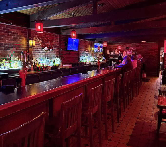 Step into a world where time slows down – the bar's warm brick walls and red lighting create the perfect backdrop for serious food appreciation.