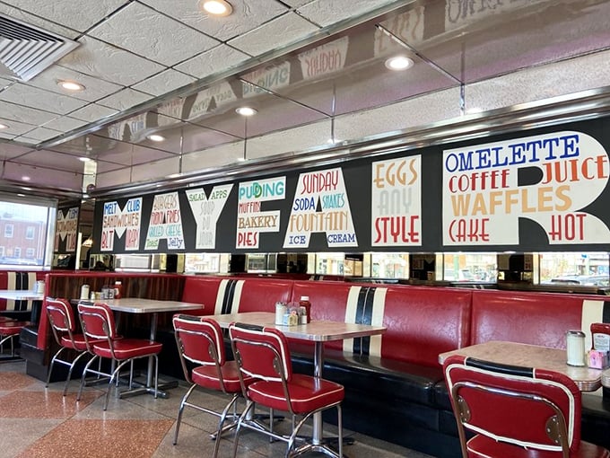 Red vinyl booths and colorful menu boards create the perfect backdrop for morning conversations and coffee refills that never end.