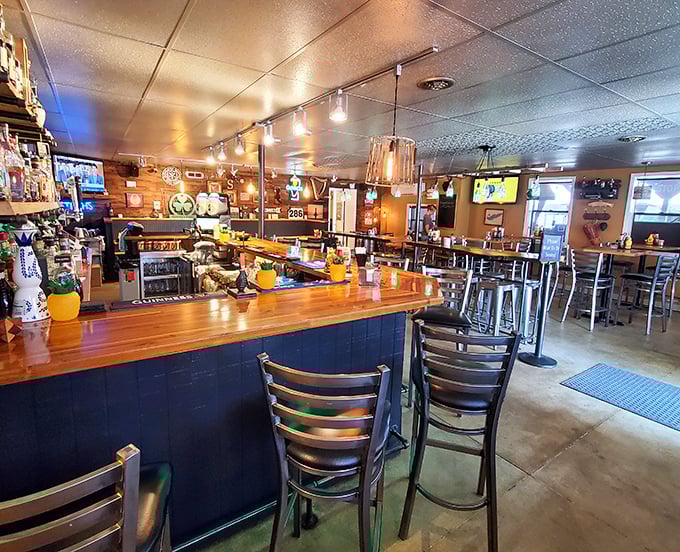 The bar at Sparky's isn't just a counter—it's command central for culinary happiness, where wood-paneled walls hold stories as rich as their sauces.