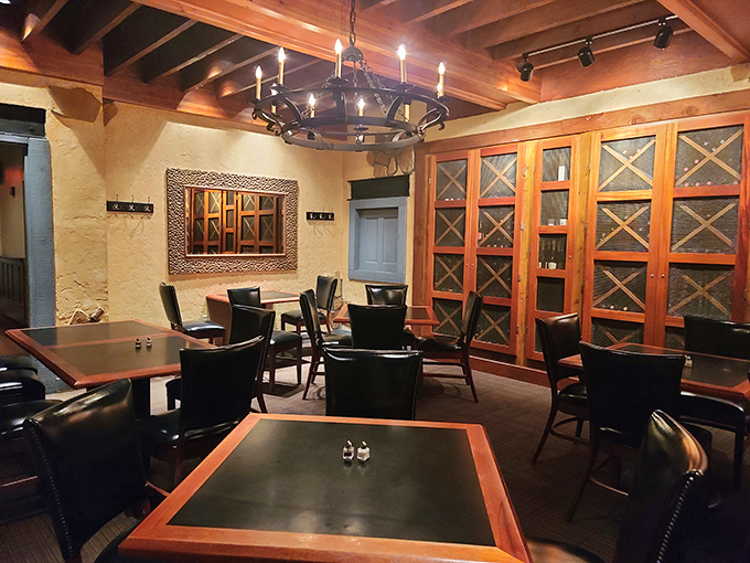 Wine cabinets line the walls of this intimate dining space, where rustic wooden beams and soft lighting create the perfect backdrop for memorable meals and whispered confessions.