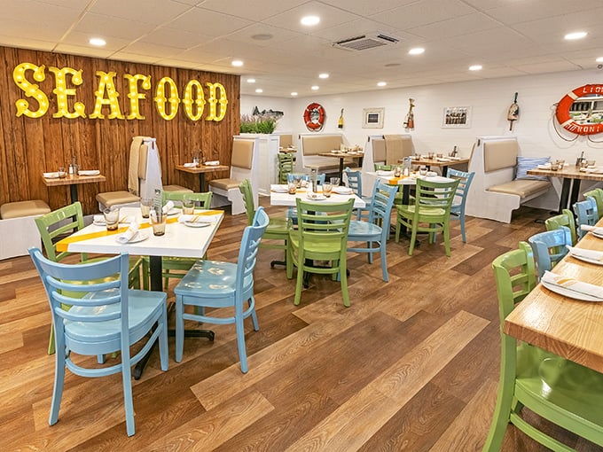 Step inside and the glowing "SEAFOOD" sign leaves no doubt about the mission here—those colorful chairs aren't just cheerful, they're waiting for your seafood revelation.
