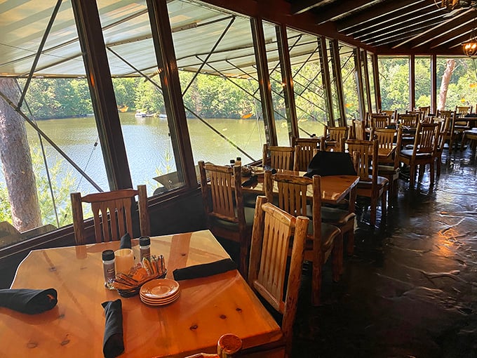 Floor-to-ceiling windows transform ordinary dining into a treetop experience, with Mirror Lake providing nature's dinner theater alongside your meal.