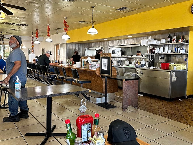 Where breakfast dreams come true: The open kitchen design lets you witness the morning magic happen while counter seats offer front-row views to the culinary choreography.