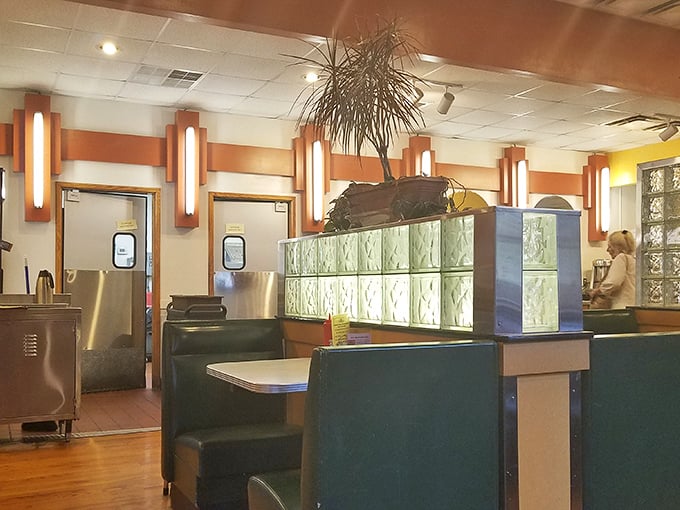 Classic diner aesthetics meet cozy comfort with glass block dividers and warm lighting. This isn't Instagram-bait design—it's the real deal where conversations flow as freely as the coffee.