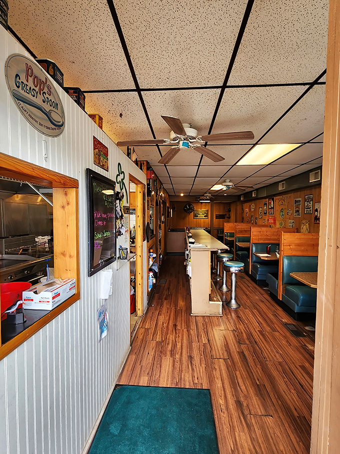 Step inside and time slows down – narrow wooden floors, classic booths, and that "Pop's Greasy Spoon" sign promising honest food that prioritizes taste over trends.