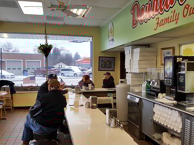 Counter culture at its finest—where regulars exchange neighborhood news over coffee while eyeing their next donut conquest.